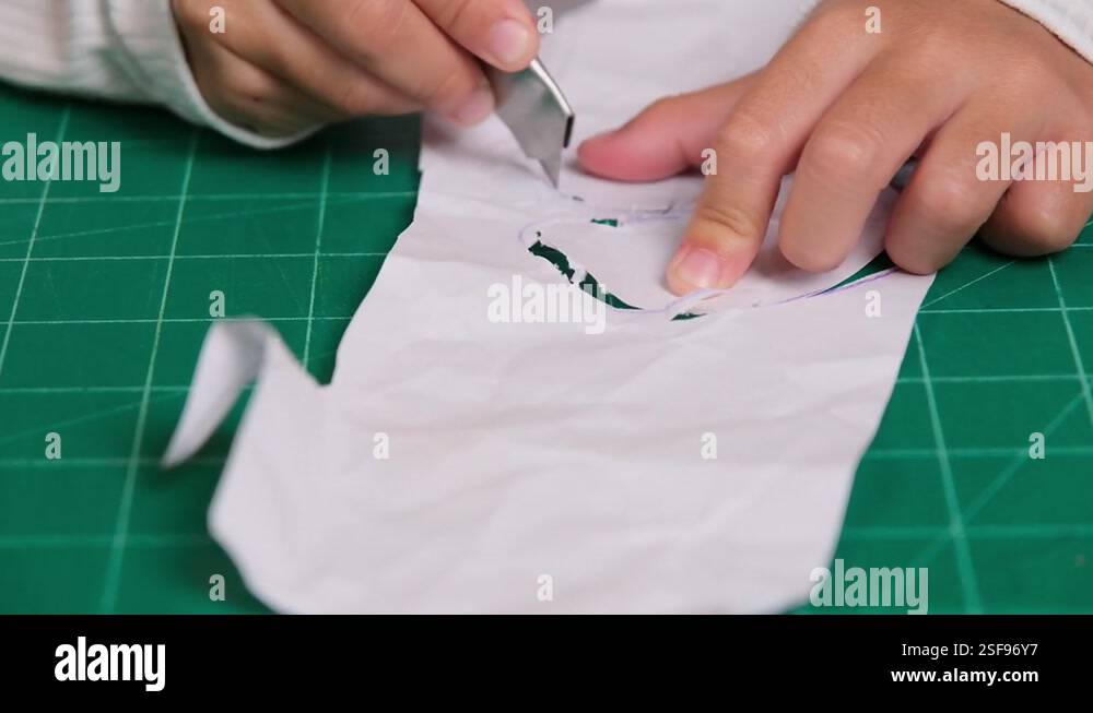 Child cutting paper with cutter knife alone, dangerous situation at ...
