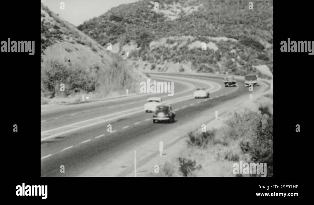 1950s: Four-lane divided highway going around hills or mountains. Slow ...