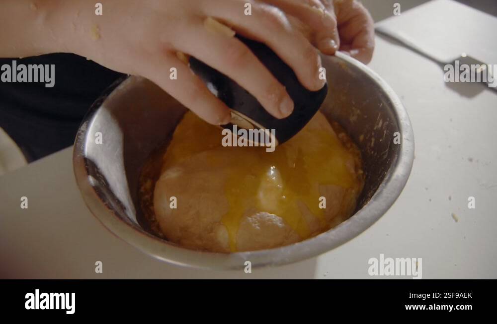 Young Female pouring molten butter on dough for a cake in the kitchen ...