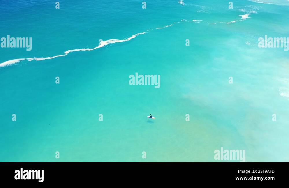 High Angle of surfer alone in ocean, waiting on waves Stock Video ...