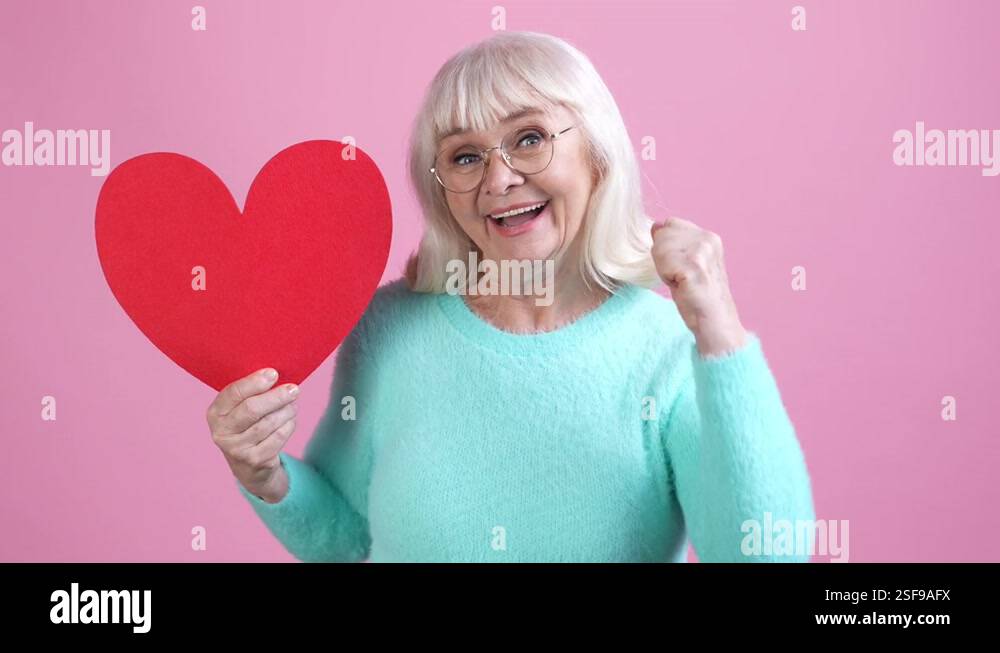 Old granny hold card heart present fist up isolated pastel color ...