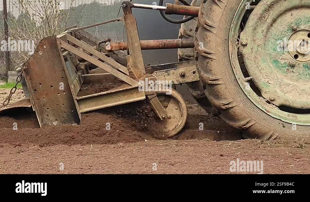 Tractor plowing ground. Close-up of movement of tractor wheels and ...