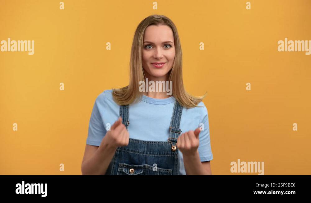 Portrait female in denim overalls asking joining her come here waving ...