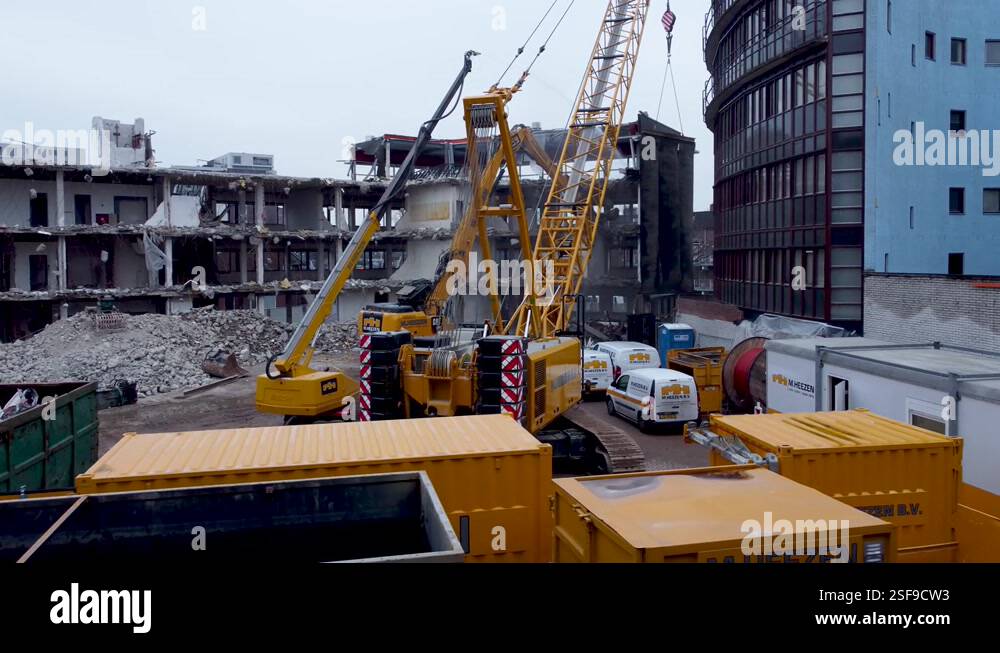 Demolition of a police station using building hydraulic shears, aerial ...