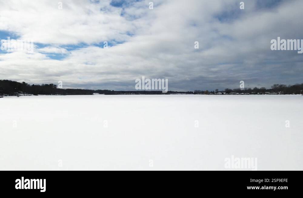 Fast and long, pushing forward in harsh winds over iced lake Stock ...