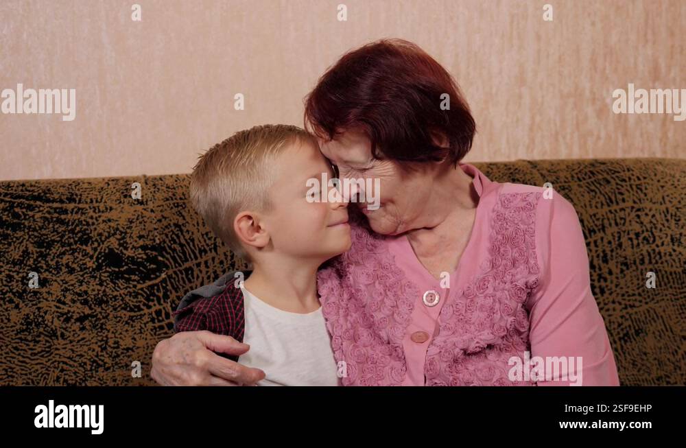 Portrait of a happy great-grandmother and beloved grandson at home on ...