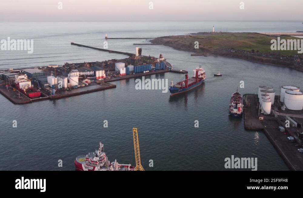 Aerial view of a cargo ship entering Aberdeen harbour at sunset Stock ...