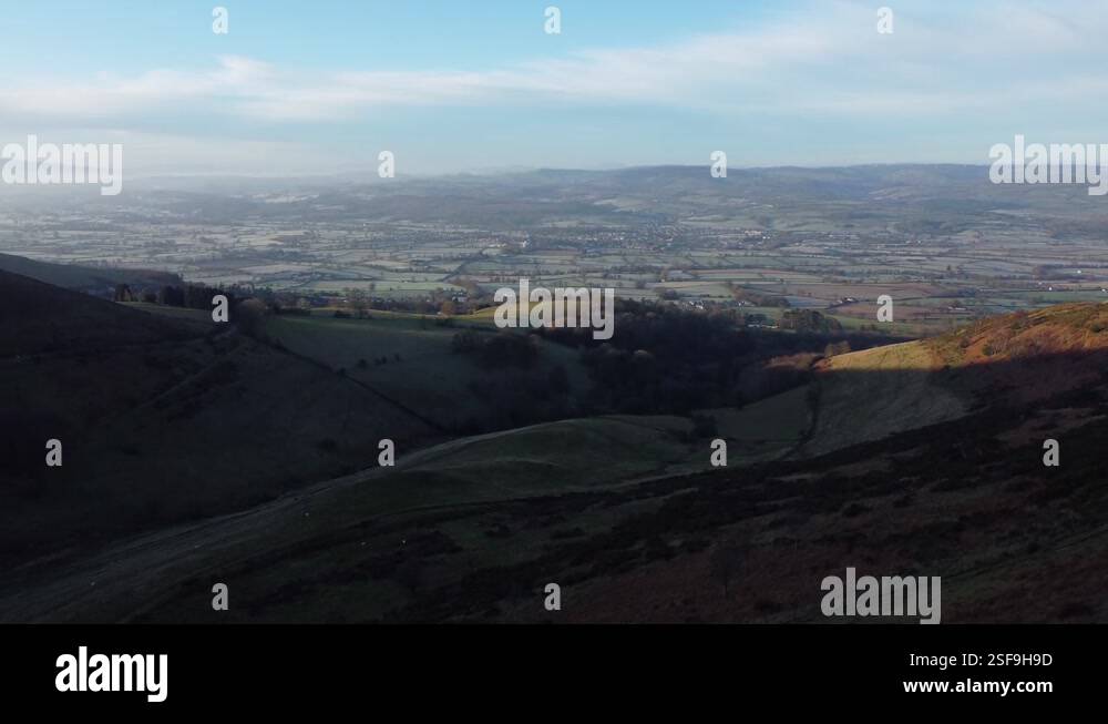 Distant misty layers of panoramic rural mountain valley countryside at ...