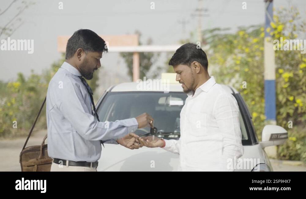 cab driver receiving car key from bank officer in front of car ...