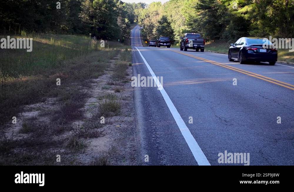 Traffic on a rural road in Georgia cars and trucks passing Stock Video ...