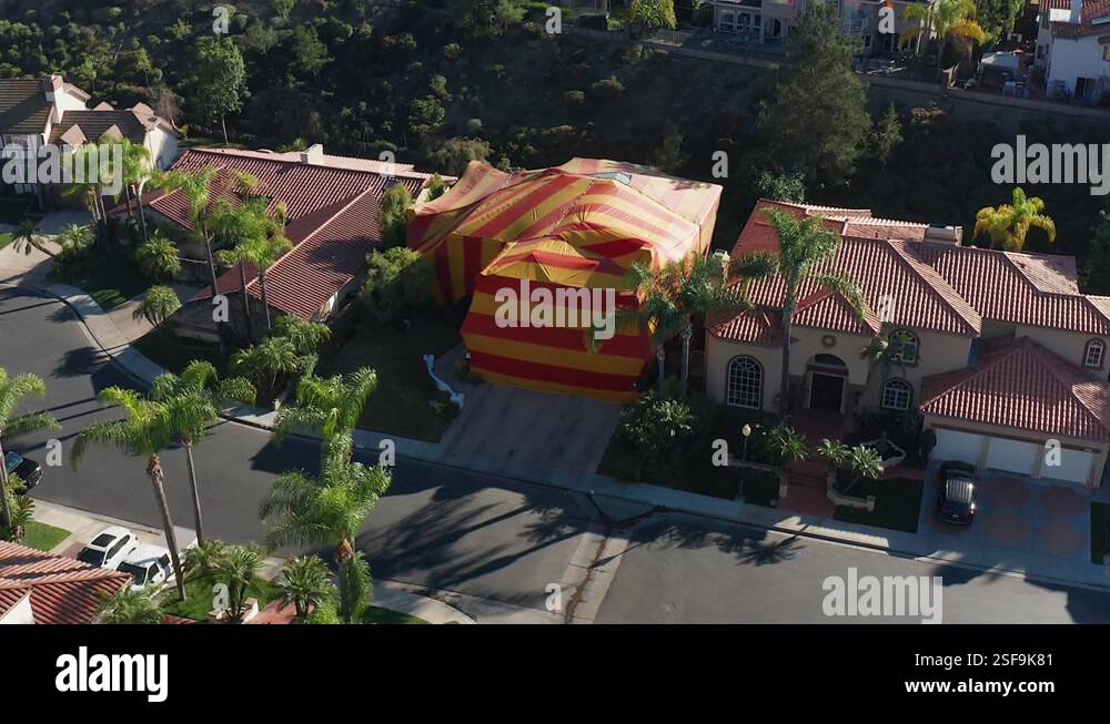 Aerial view of a two story house that has been tented for a bug Stock ...
