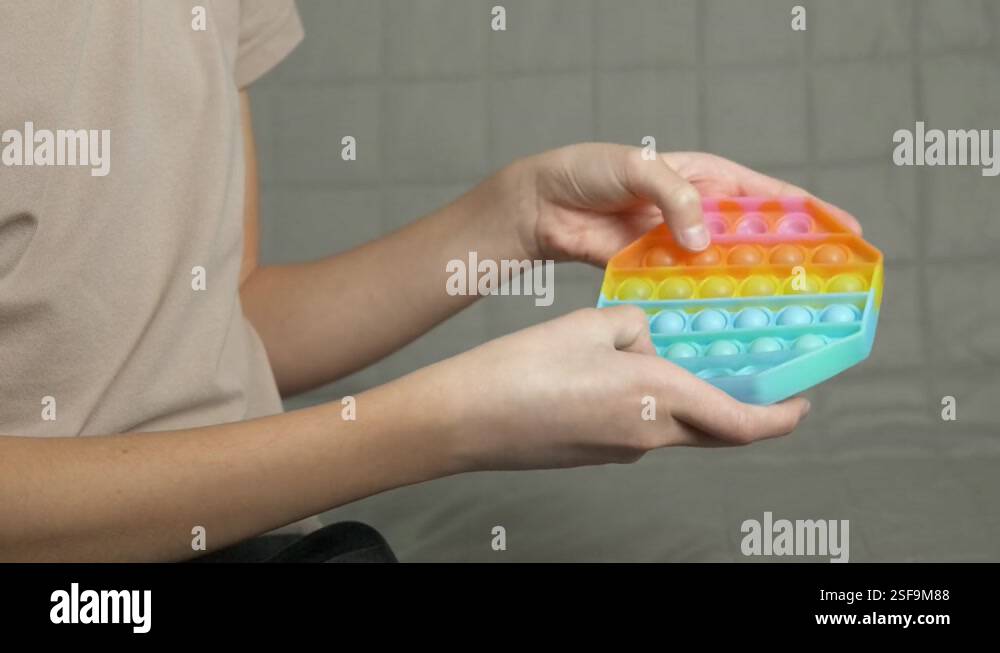 Fingers on pop it Stock Video Footage - Alamy