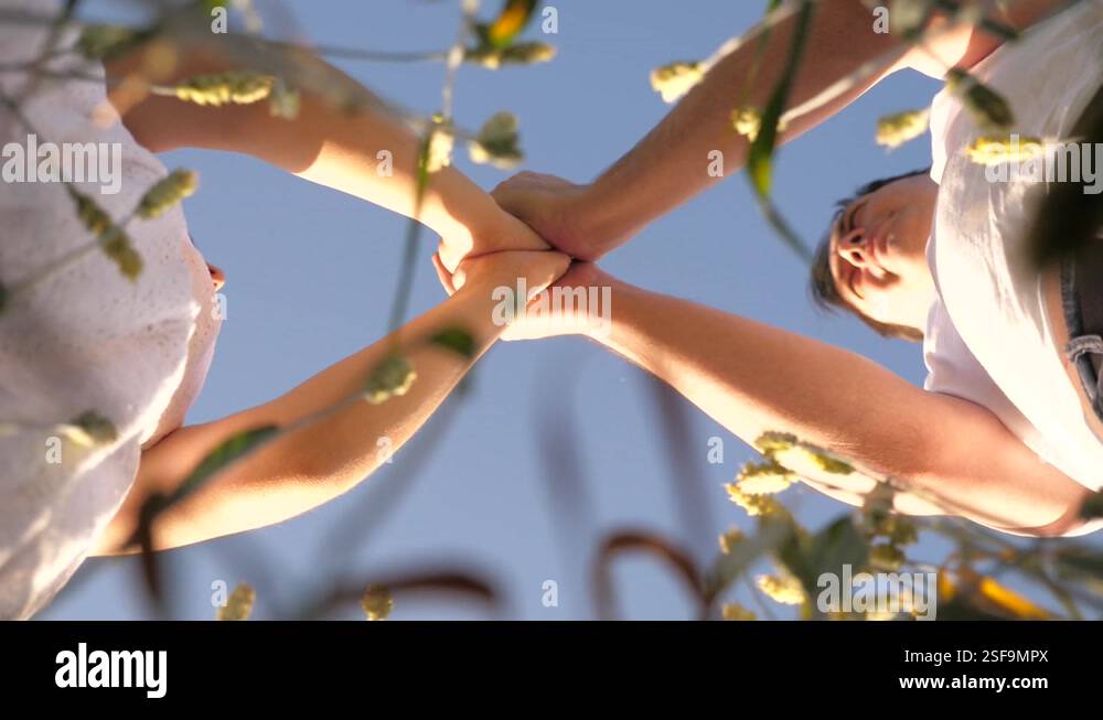 Enamored man and woman hold hands outdoors. lose-up hand in hand. Happy ...