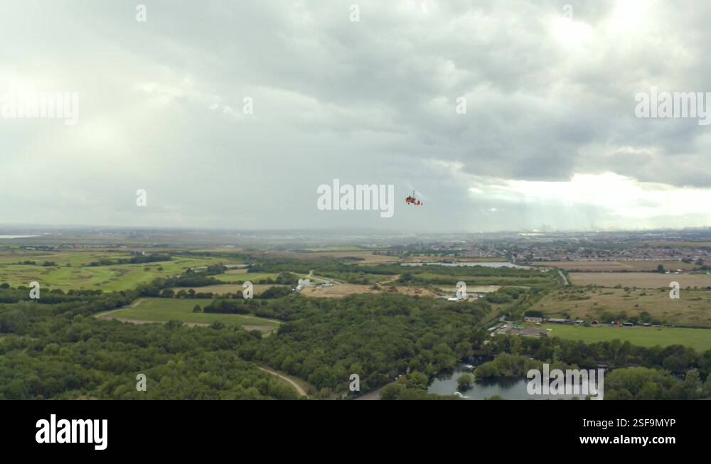 Gyrocopter 4k CINEMATIC FLYAWAY above trees and fields. Long shot Stock ...
