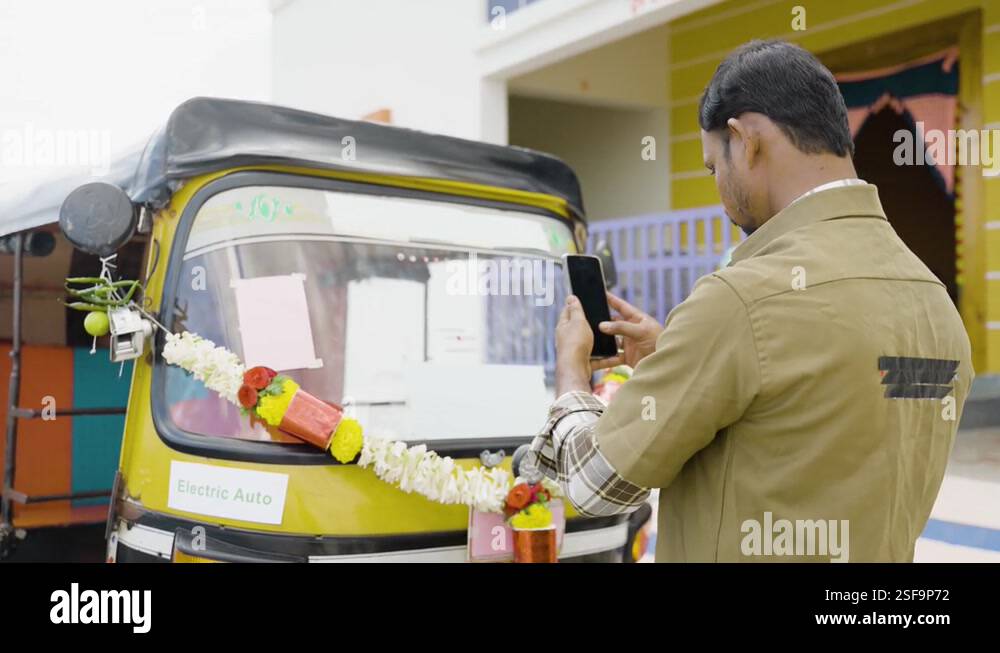 Driver busy taking picture of his new auto Rickshaw before driving to ...