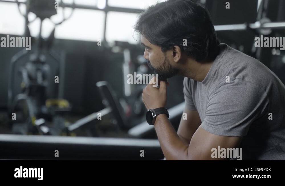 Young Indian bodybuilder thinking after workout at gym - Concept of ...
