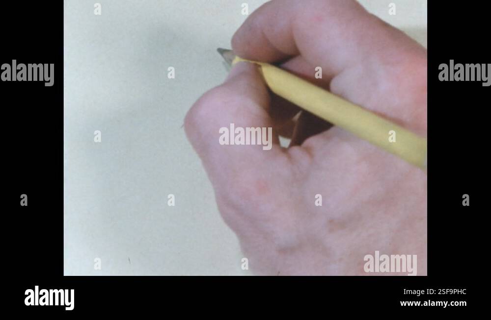 1960s: Writing on paper. Close up, pencil writing equation on paper ...