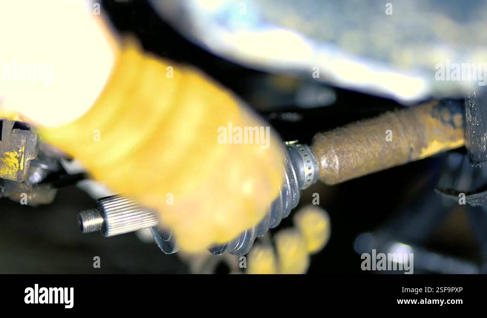 installation of a new CV joint on a car drive in a car service Stock ...