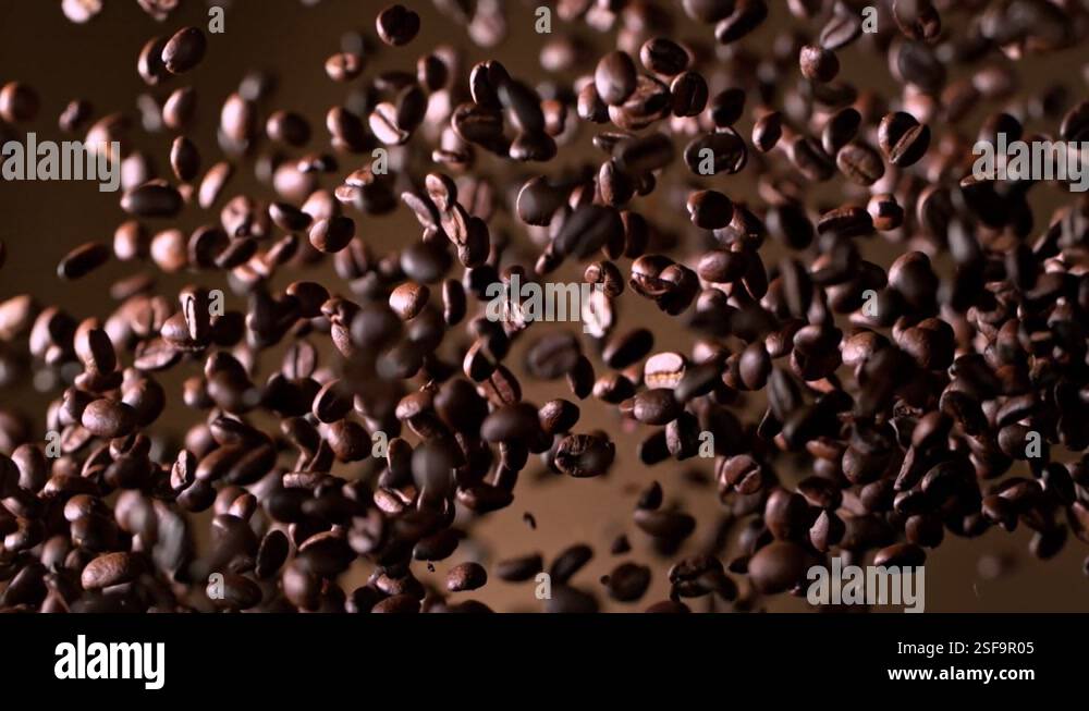 Super Slow Motion Shot of Exploding Premium Coffee Beans on Brown ...