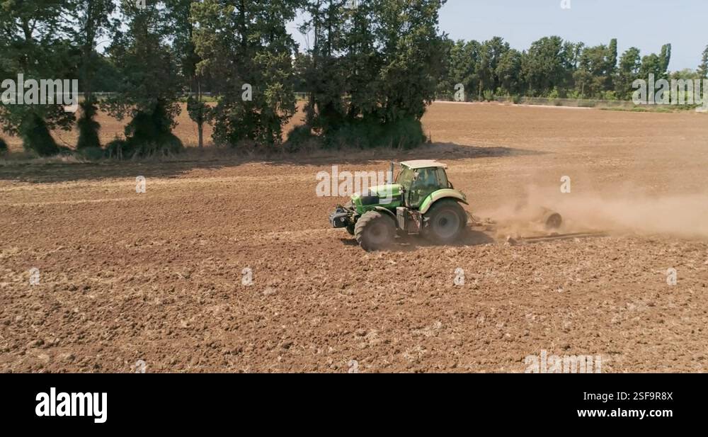 Aerial view of a tractor ploughing an empty field, Kibbutz saar, Israel ...