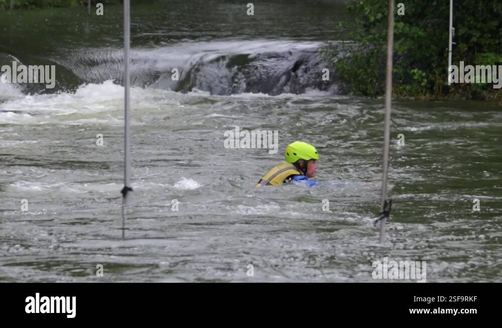 Person in river wearing lifejacket and helmet after falling out kayak ...