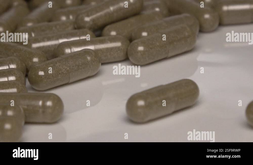 slow motion of many green medical capsules, iron supplement rolling. 4K ...