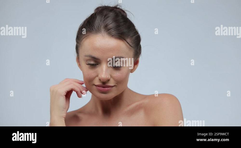 Beauty portrait of good-looking woman who softly touches her chin with ...