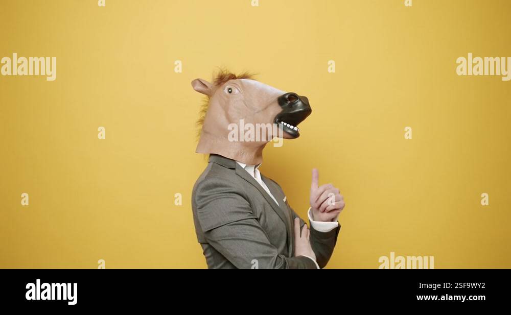 The man in the horse mask is gesturing. he has an idea and is shocked ...