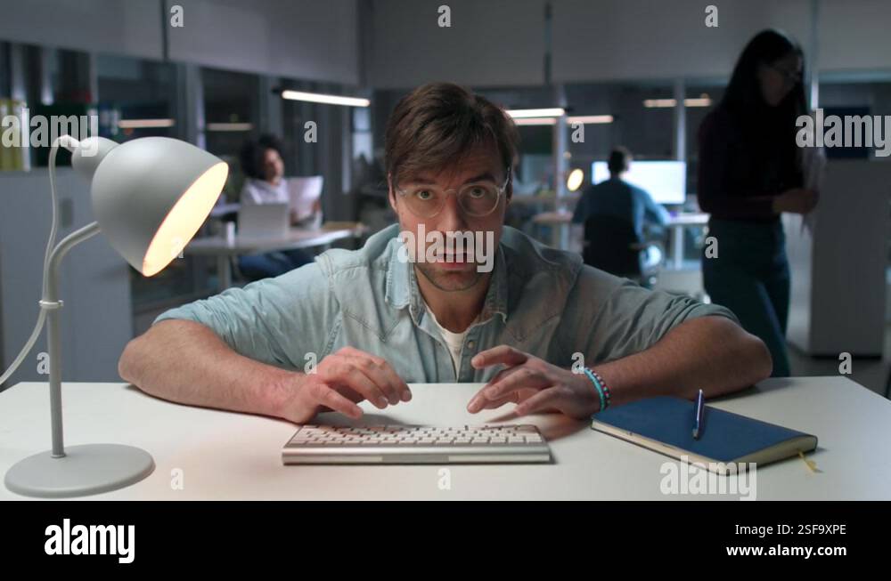 Portrait of shocked businessman staring at computer screen working late ...