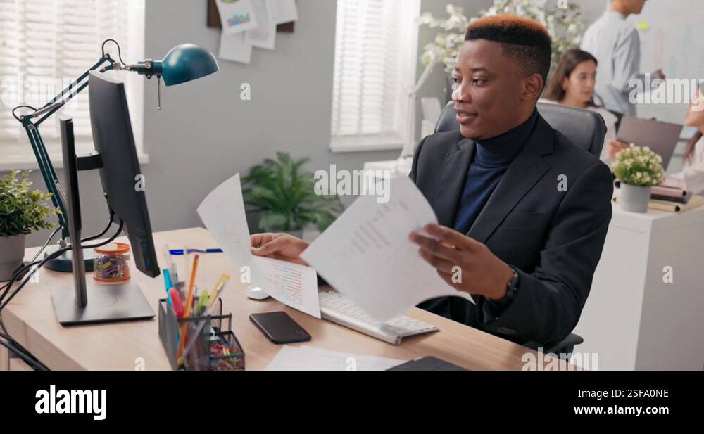 Boss working in an office man is sitting behind desk in front of ...