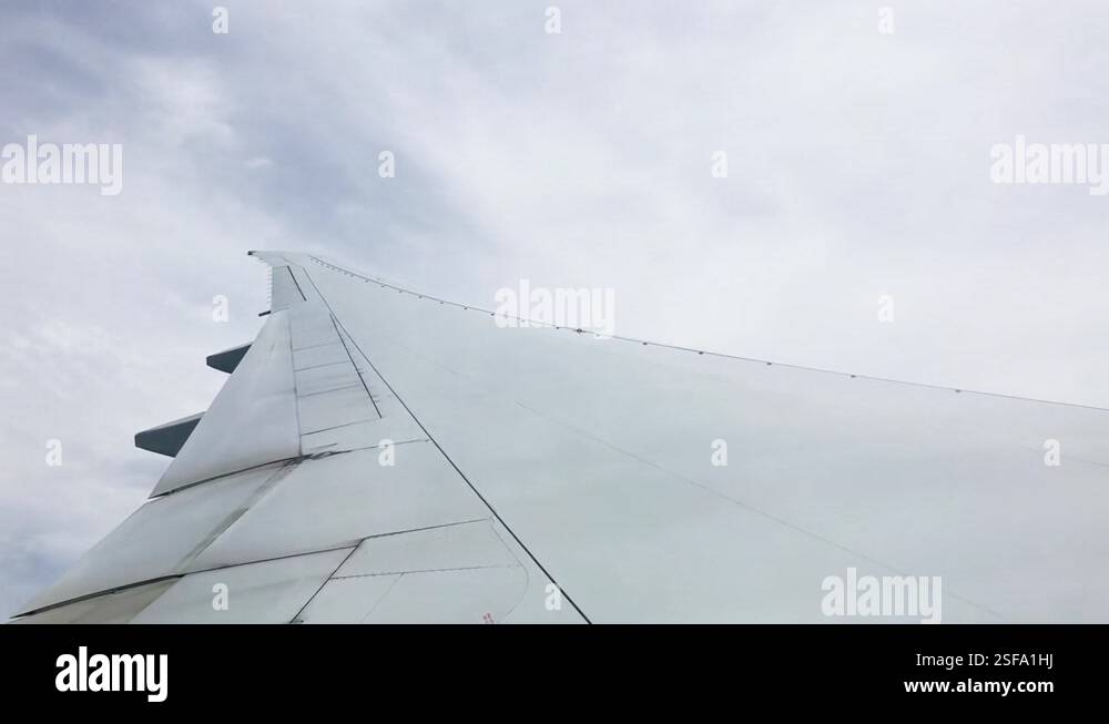 Looking through window aircraft during flight next to the wing with sky ...