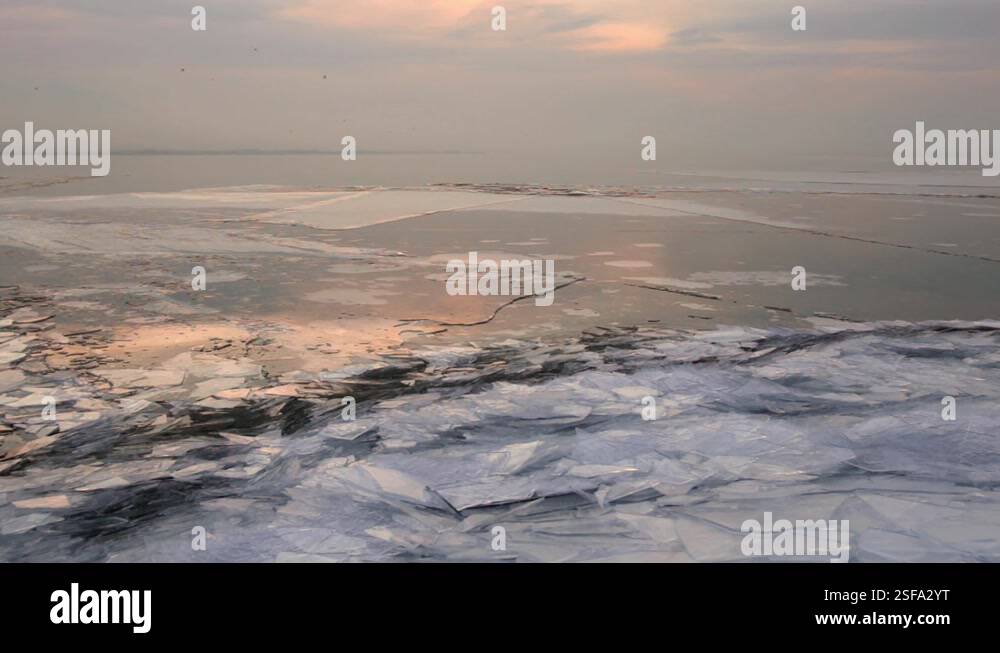 Utah Lake pushing ice layer into shore as it cracks and breaks Stock ...