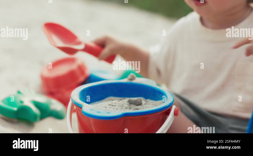 A child plays in the sandbox, a little boy spends childhood in the ...