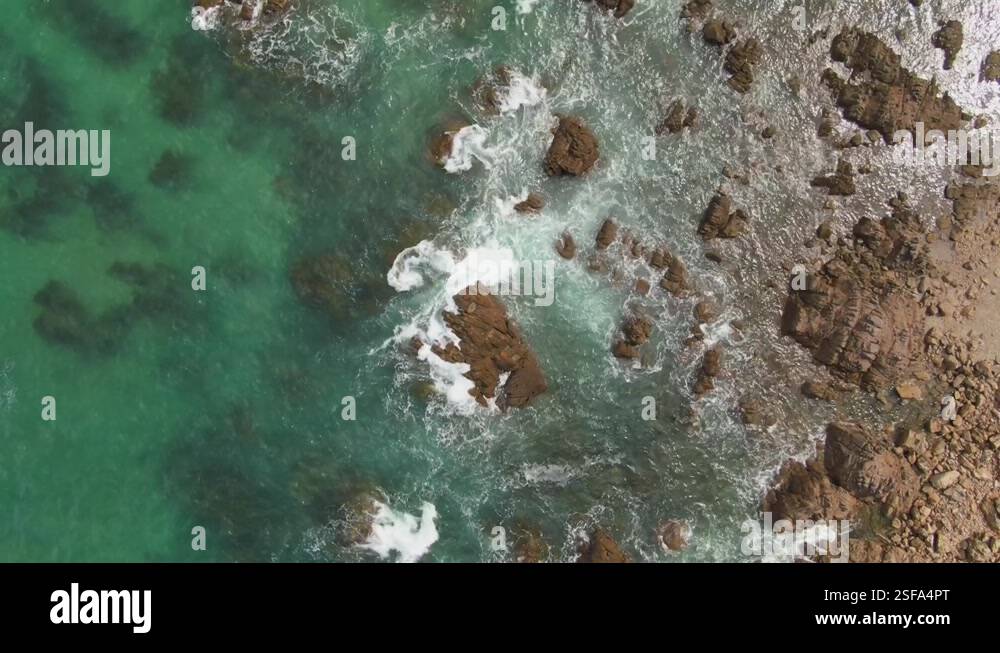 4k Aerial rocky coast with turquoise water - Drone overhead shot Stock ...