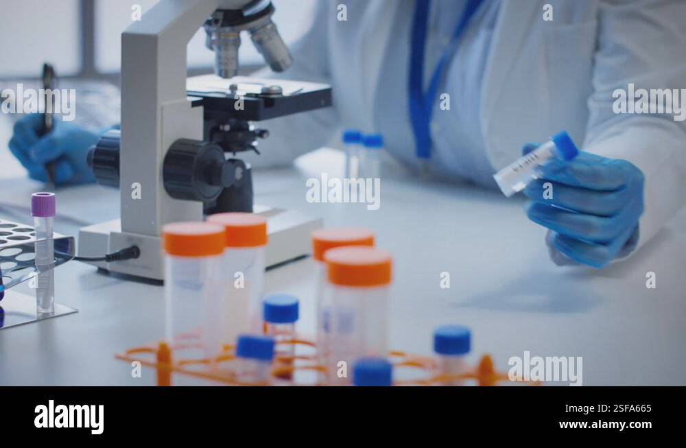 Close Up Of Lab Worker Conducting Research Using Microscope Holding ...