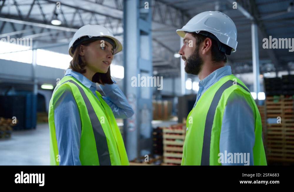 Factory workers shaking hands discussing production inspecting ...