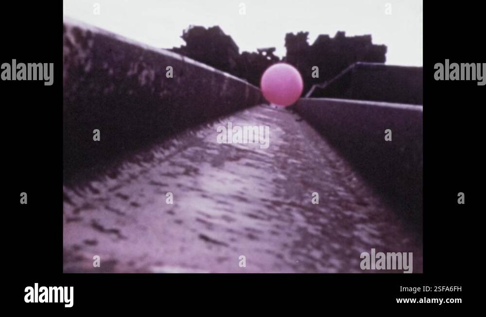 1960s: Ball rolls down chute. Balls rolls along ground. Balls bounce ...