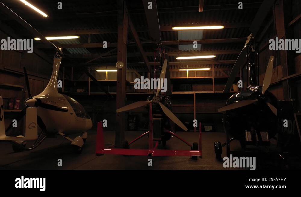 Gyrocopter 4K internal hangar arc shot 3 gyros low light Stock Video ...