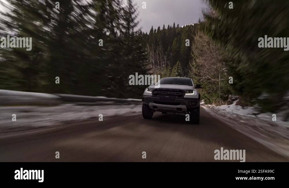 Rolling shot of Ford Ranger Raptor pickup truck car driving on mountain ...