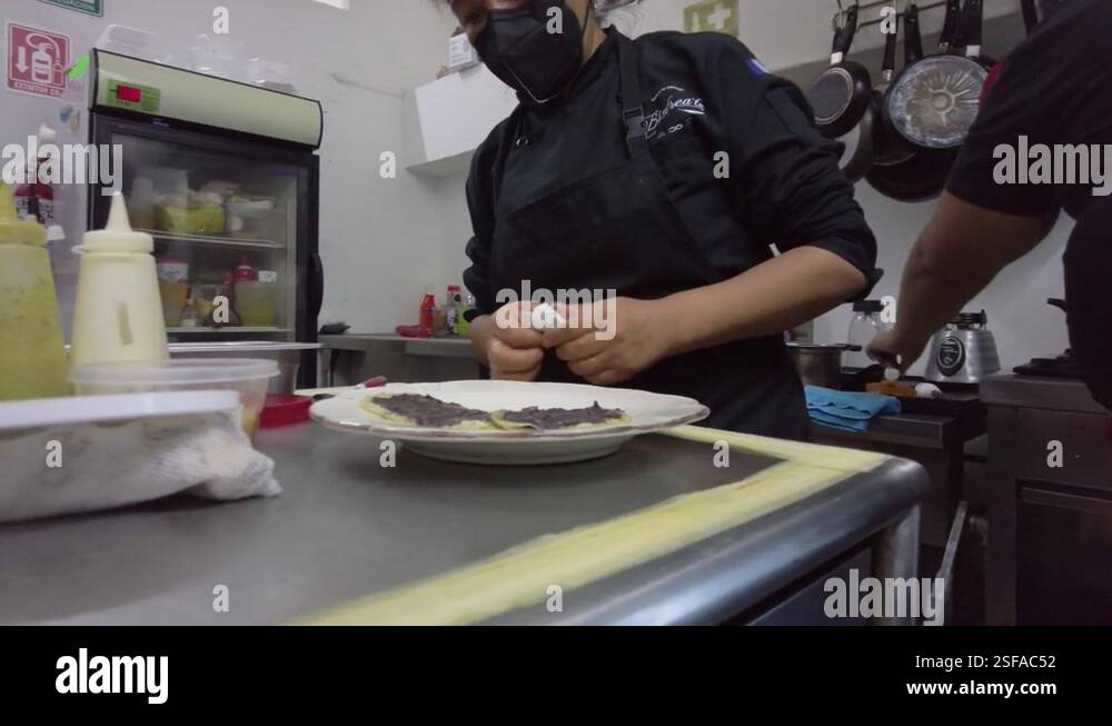 Two women chef cooks working at a diner cafe restaurant kitchen in ...