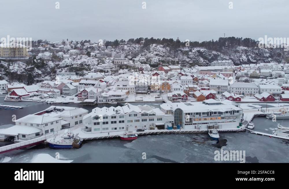 Snow-covered Buildings, Vessels, And Harbor On Frozen Water IIn Kragero ...