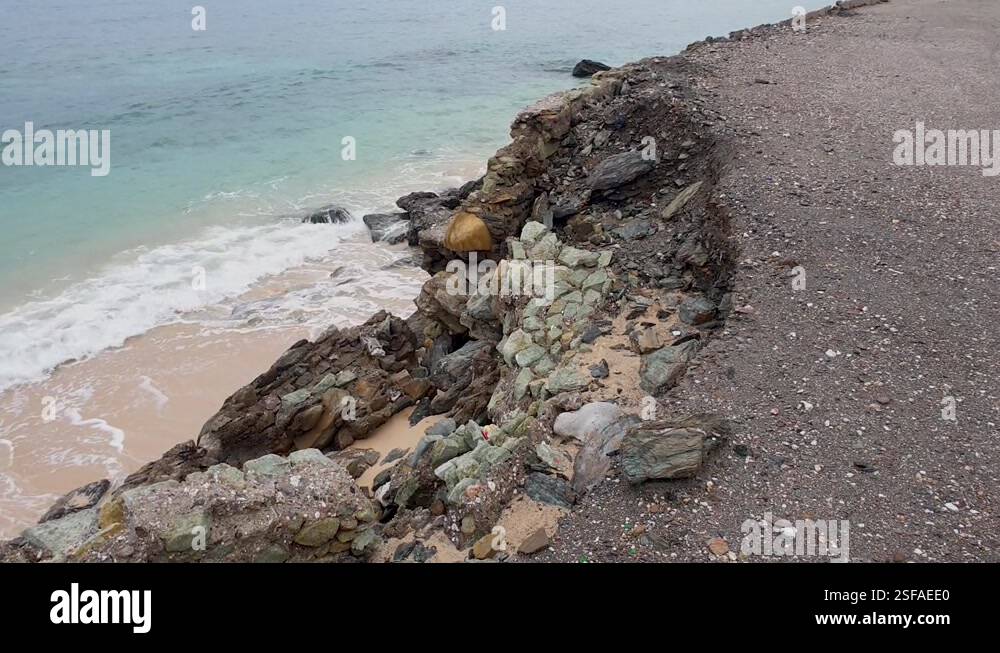 Sea wall and ocean road damage and corrosion, crumbling away into ocean ...