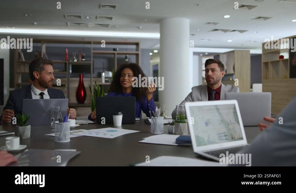 Multiethnic financial team meeting researching business strategy in ...