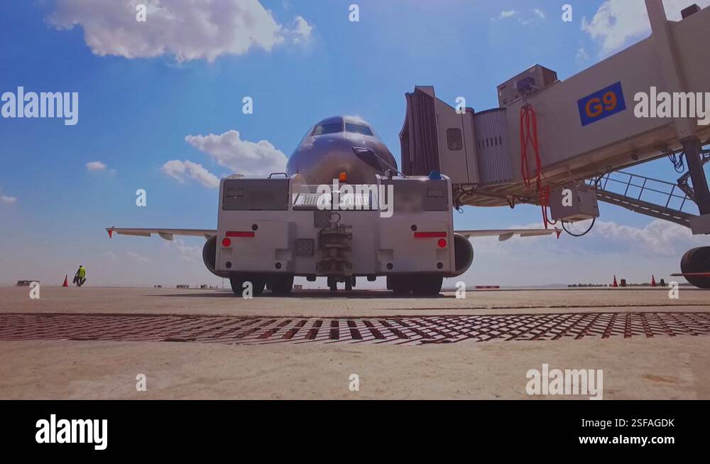 automated jet bridge is moving out from airplane, passenger transport ...