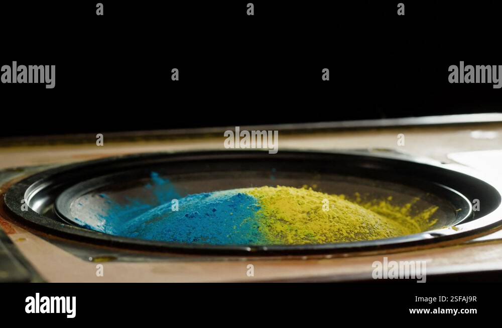 Acoustic sound system with yellow and blue paint powder. Loud music ...