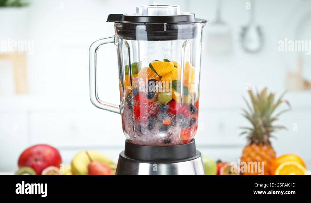 Super slow motion of mixing pieces of fruits in blender Stock Video ...