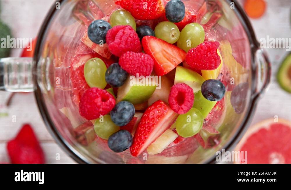 Super slow motion of mixing pieces of fruits in blender Stock Video ...