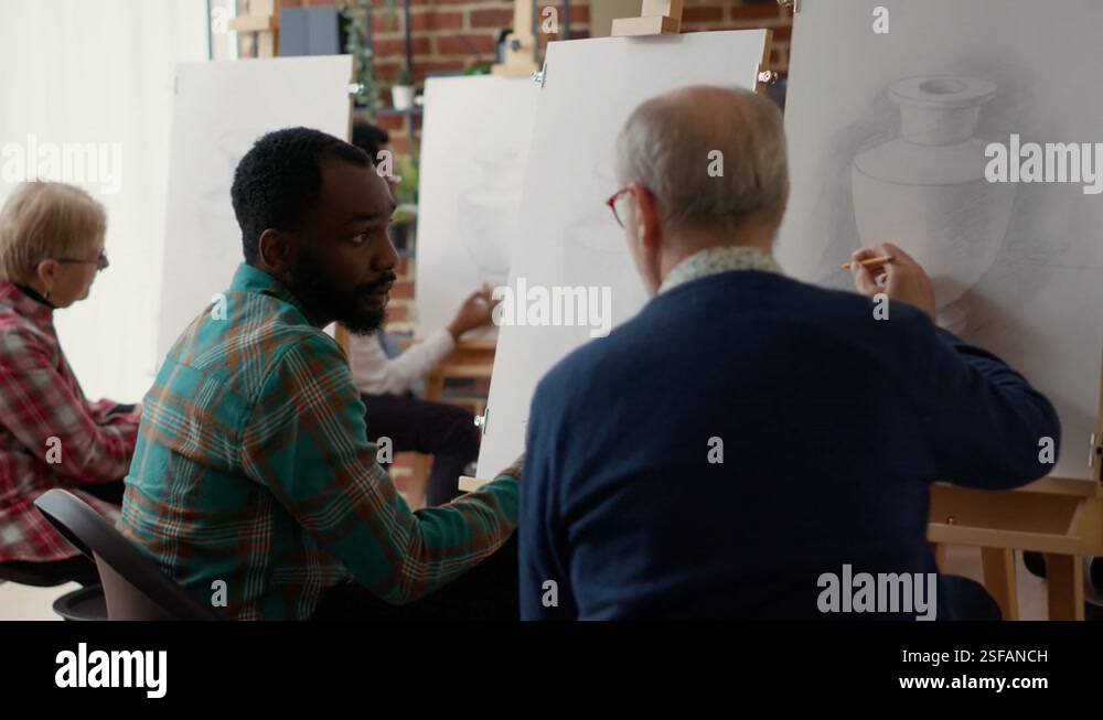 Team of art class students using pencil to draw vase design on canvas ...