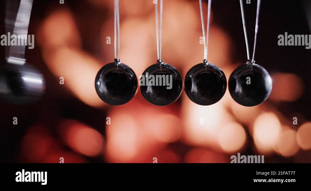 Balls in Newton's pendulum hit the background of fire. Slow-motion ...