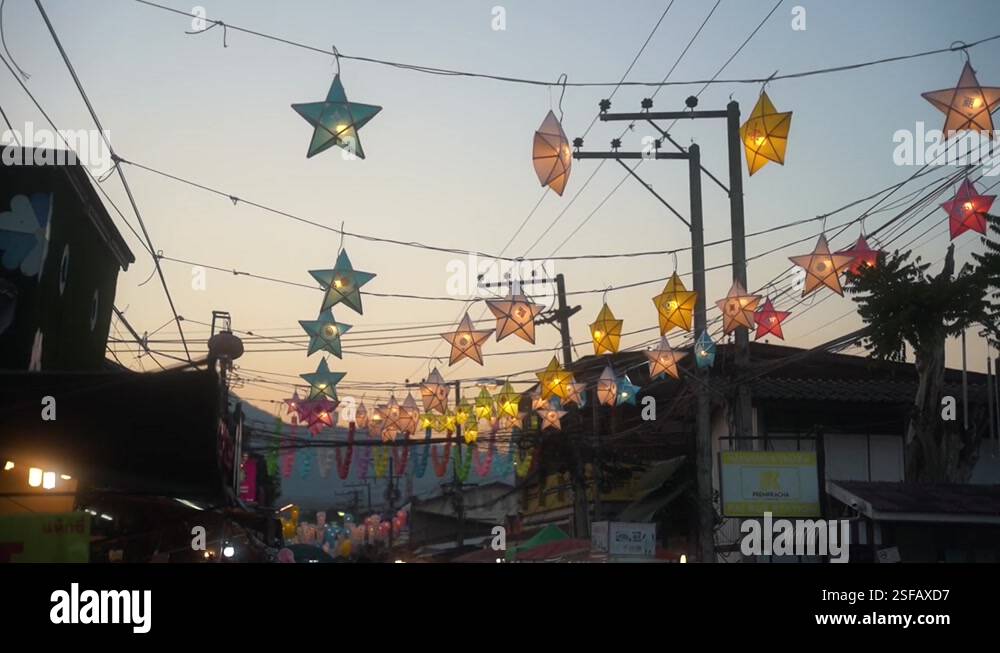 Beautiful colored stars on electricity cables above a shopping street ...